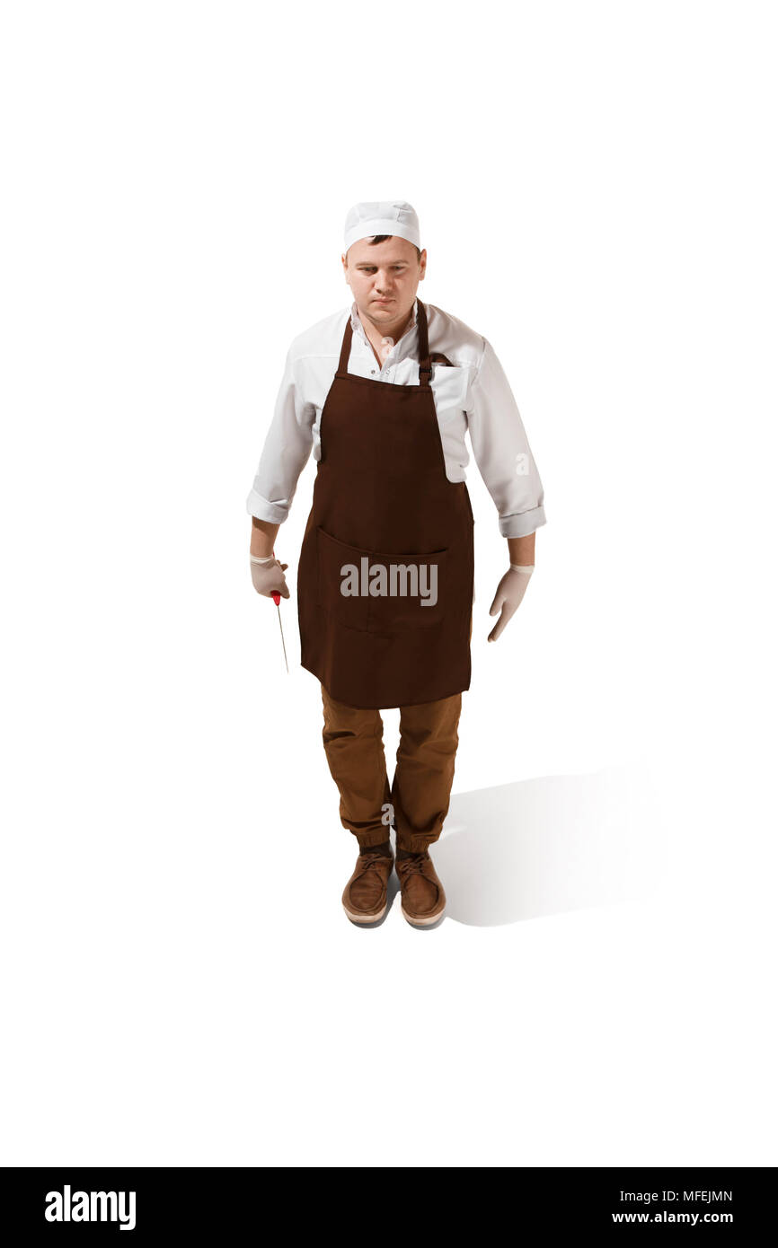Serious butcher posing with a cleaver isolated on white background ...
