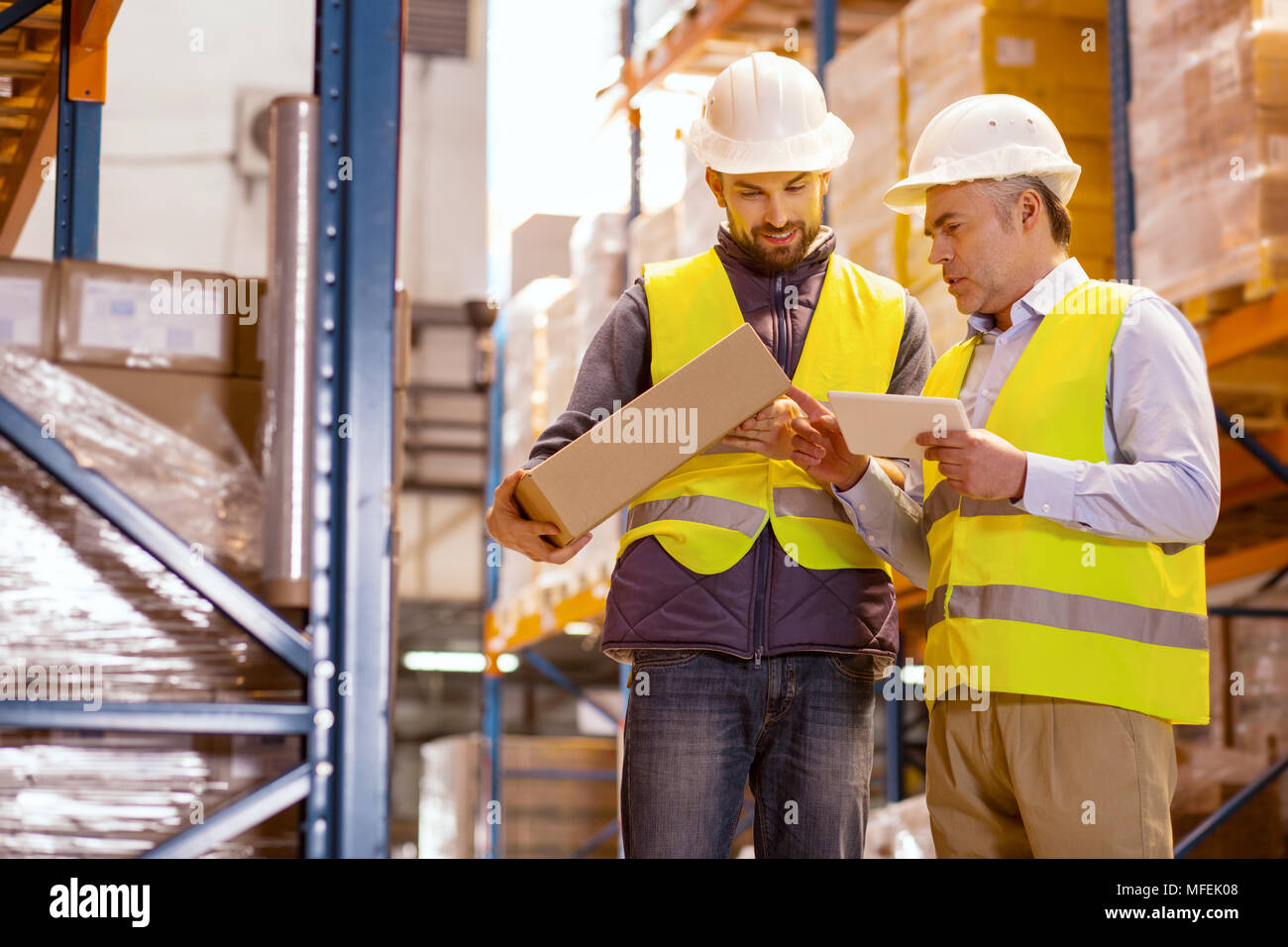 Smart nice man checking the box Stock Photo - Alamy
