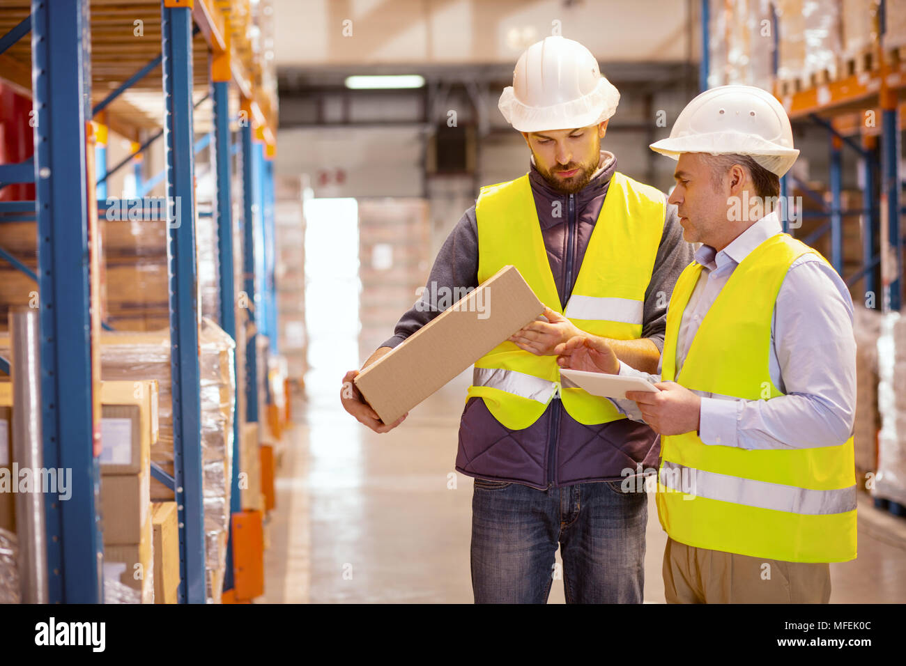 Nice serious men checking the boxes Stock Photo - Alamy