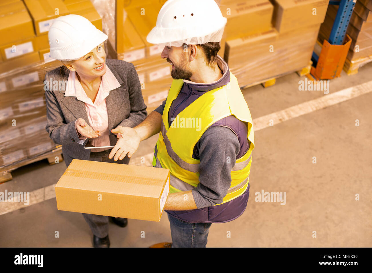 Positive nice man delivering the package Stock Photo - Alamy