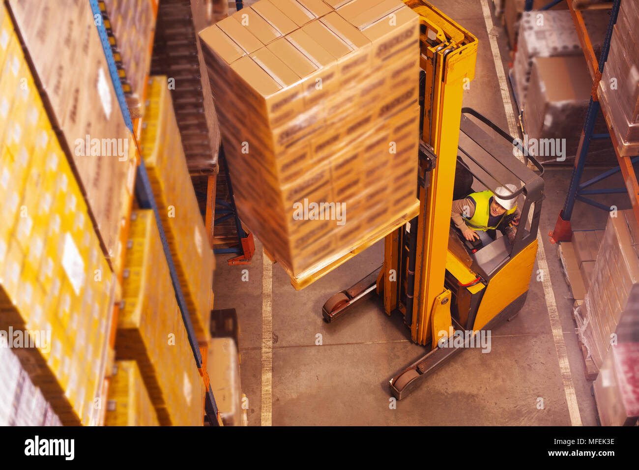 Nice smart man putting boxes of the storage shelf Stock Photo - Alamy