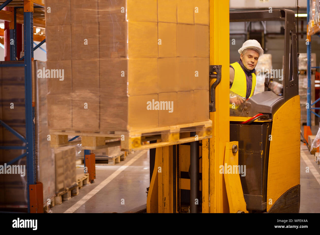 Nice smart man working in the storehouse Stock Photo - Alamy
