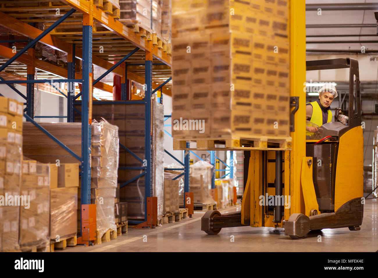 Professional warehouse worker carrying packages Stock Photo - Alamy