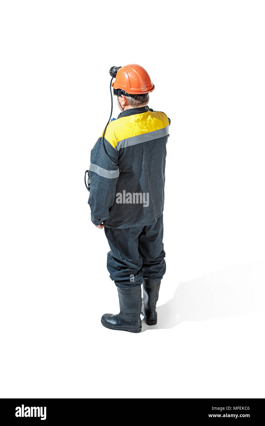 The studio shot of senior bearded male miner standing at the camera on ...