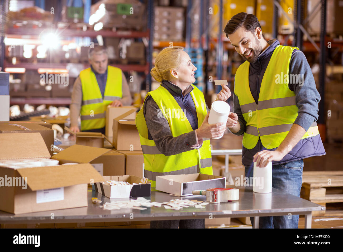 Nice warehouse workers putting labels Stock Photo - Alamy