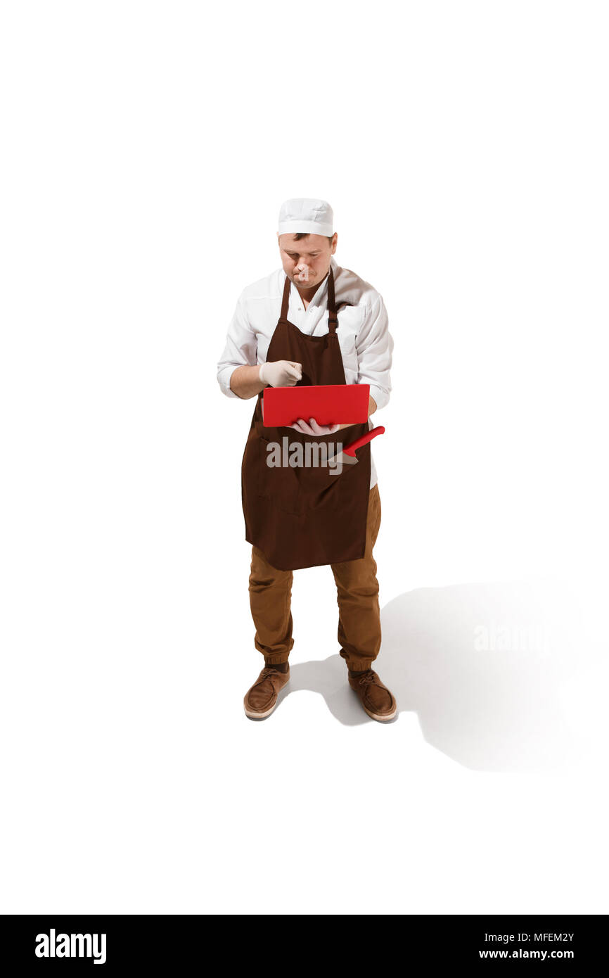 Serious butcher posing with a laptop isolated on white background Stock ...