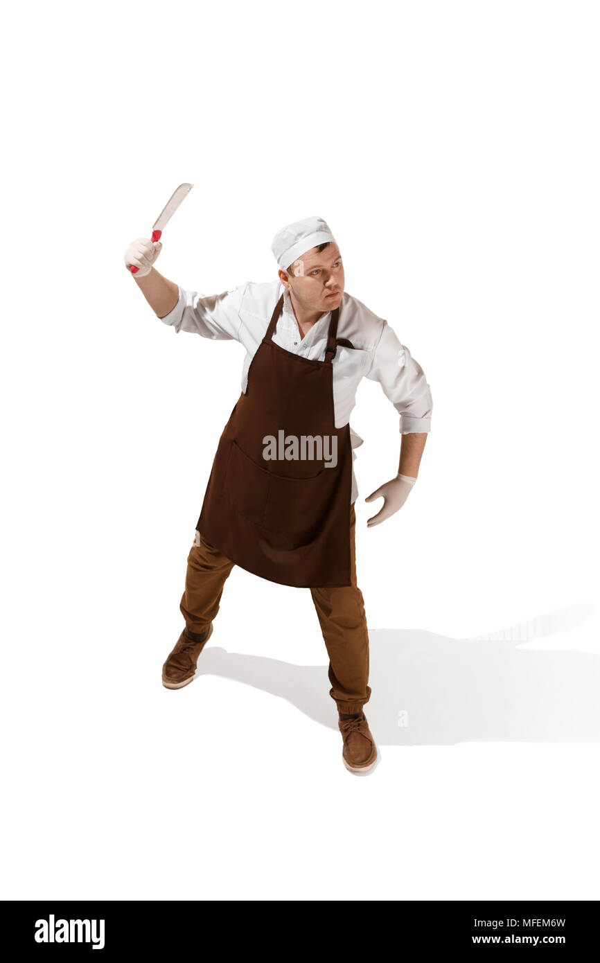 Angry aggressive butcher posing with a cleaver isolated on white ...