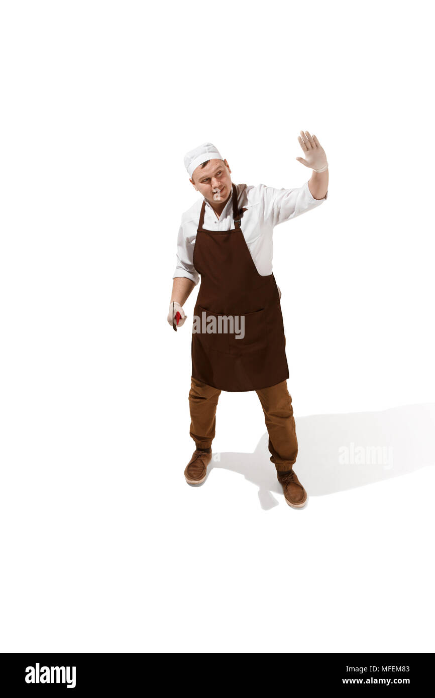 Angry aggressive butcher posing with a cleaver isolated on white ...