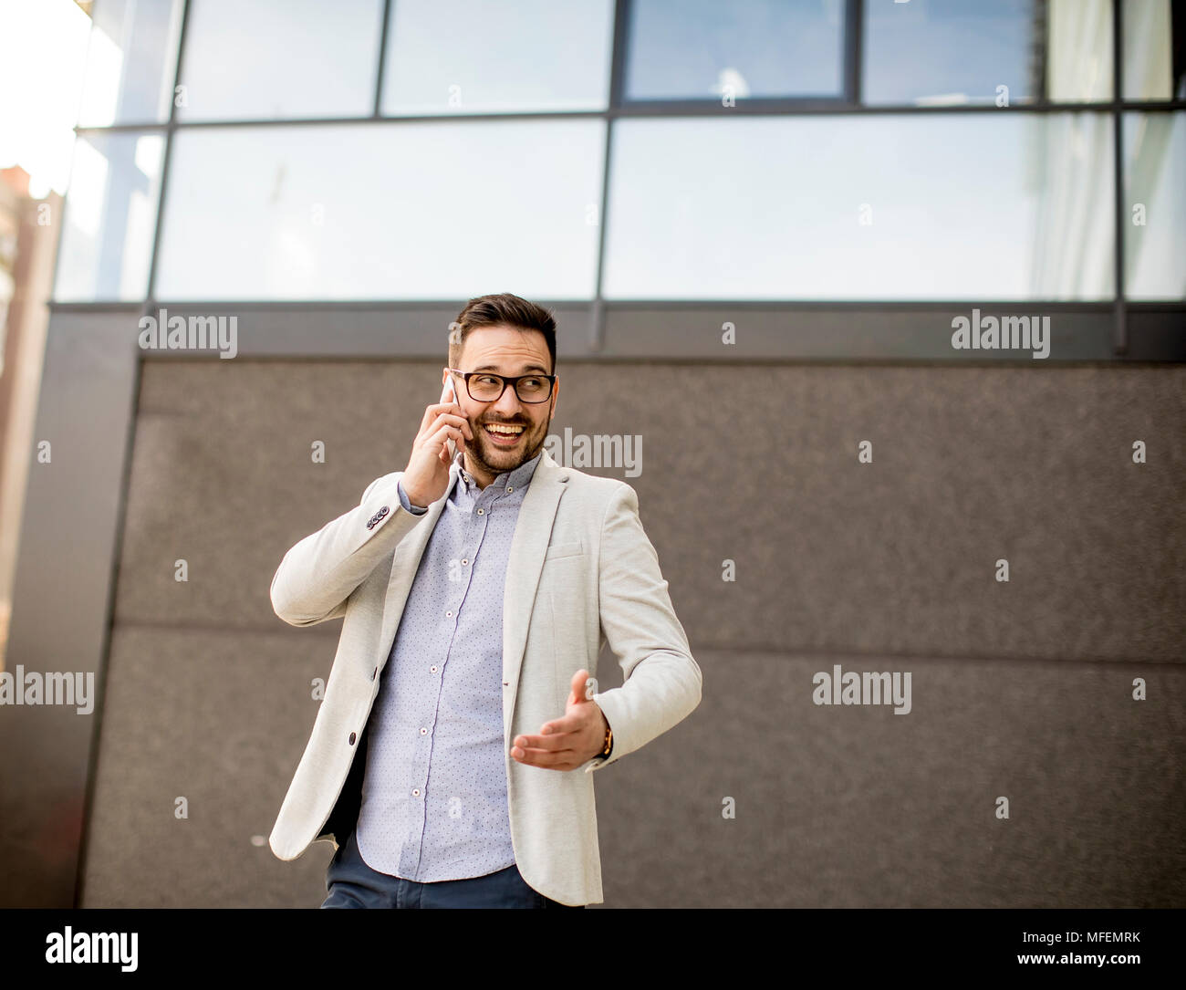 Man talking over phone walking hi-res stock photography and images - Alamy