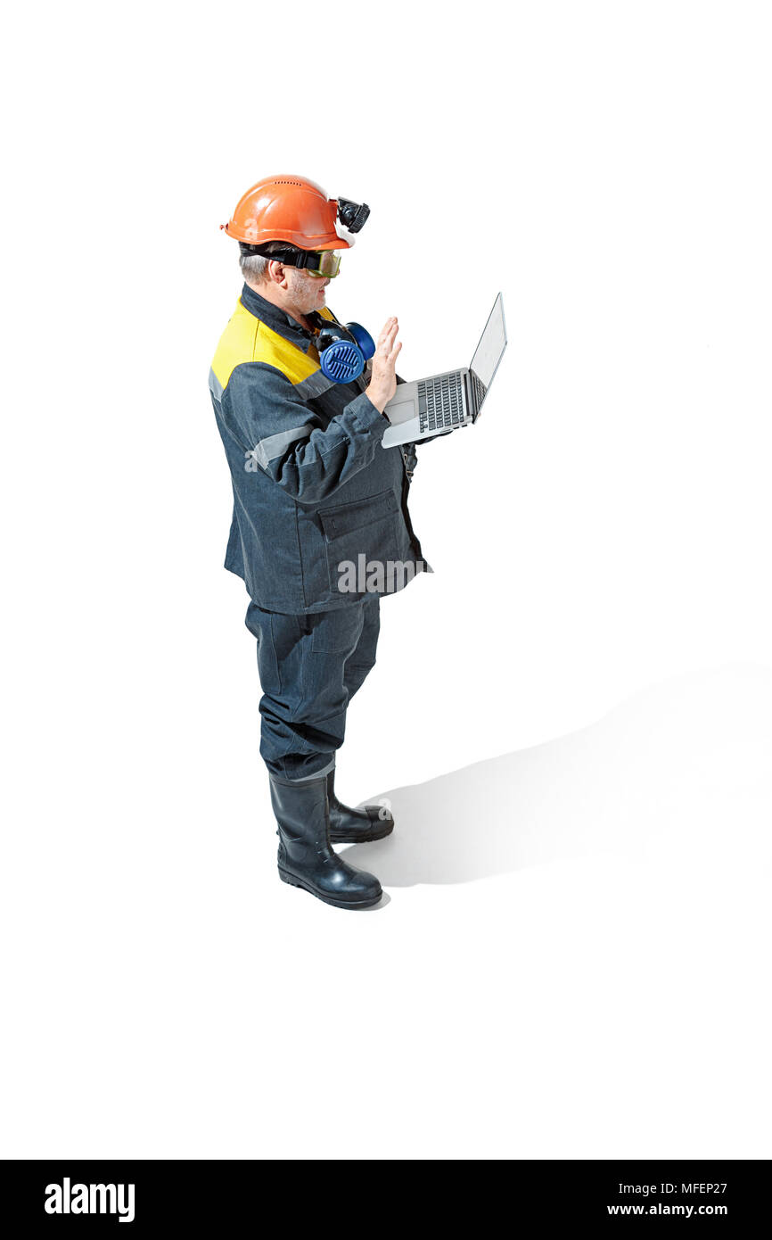 The studio shot of senior bearded male miner standing at the camera on ...