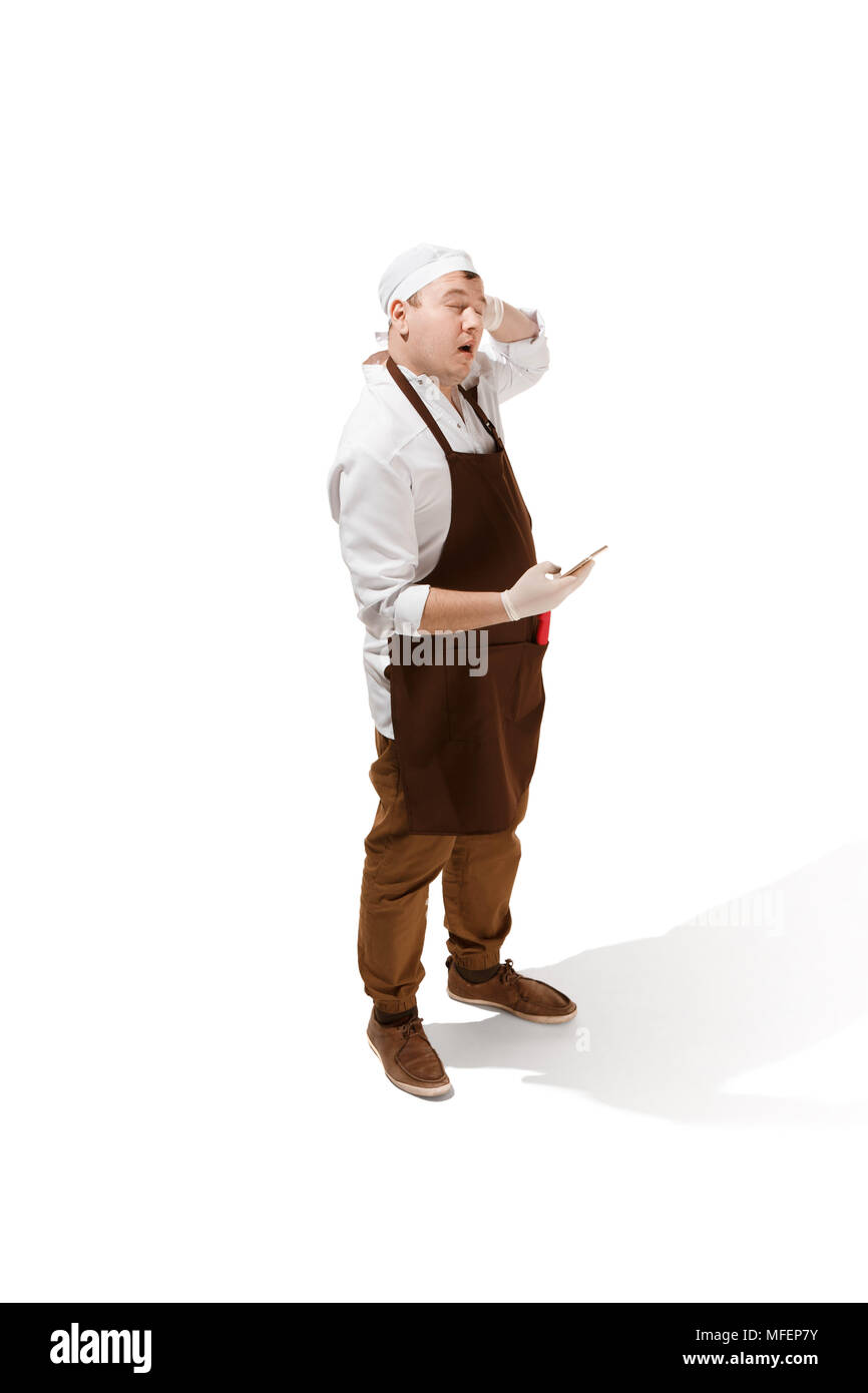 Smiling butcher posing with a cleaver isolated on white background ...