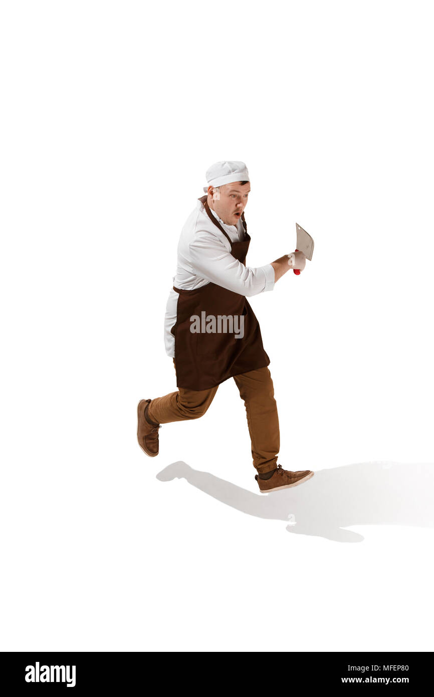 Serious butcher running with a cleaver isolated on white background ...
