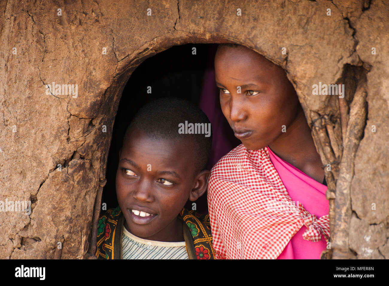 Masai children look from the doorway of a Masai house, Kenya Stock ...