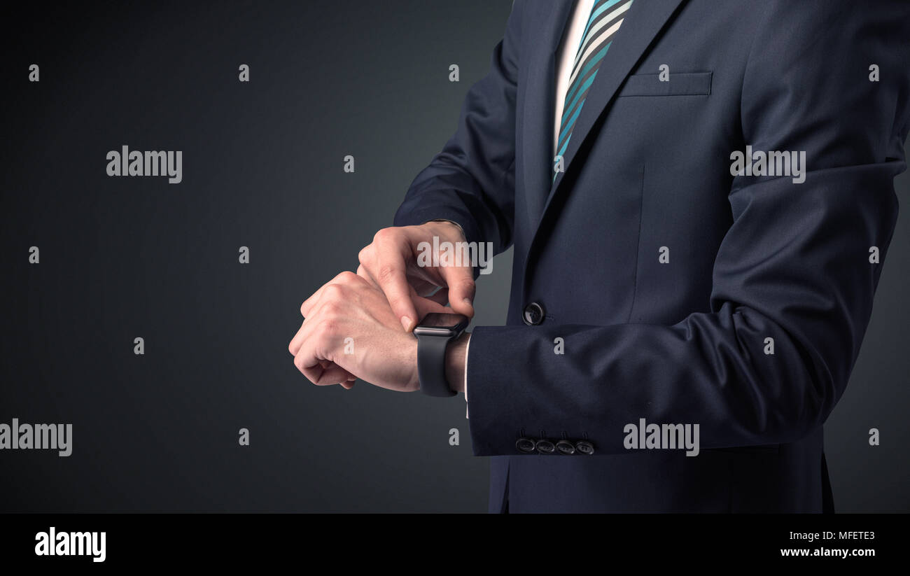 Man wearing suit with smartwatch on his wrist Stock Photo - Alamy