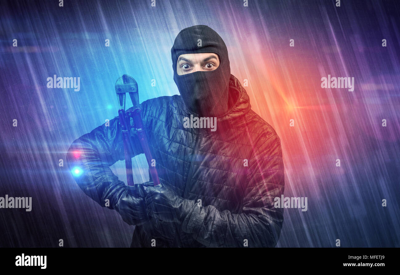 Burglar in action with colorful concept Stock Photo - Alamy