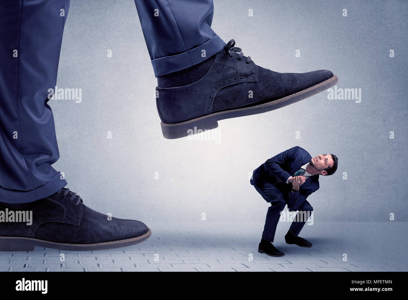 Young handsome businessman getting crushed by a big formal shoe Stock ...