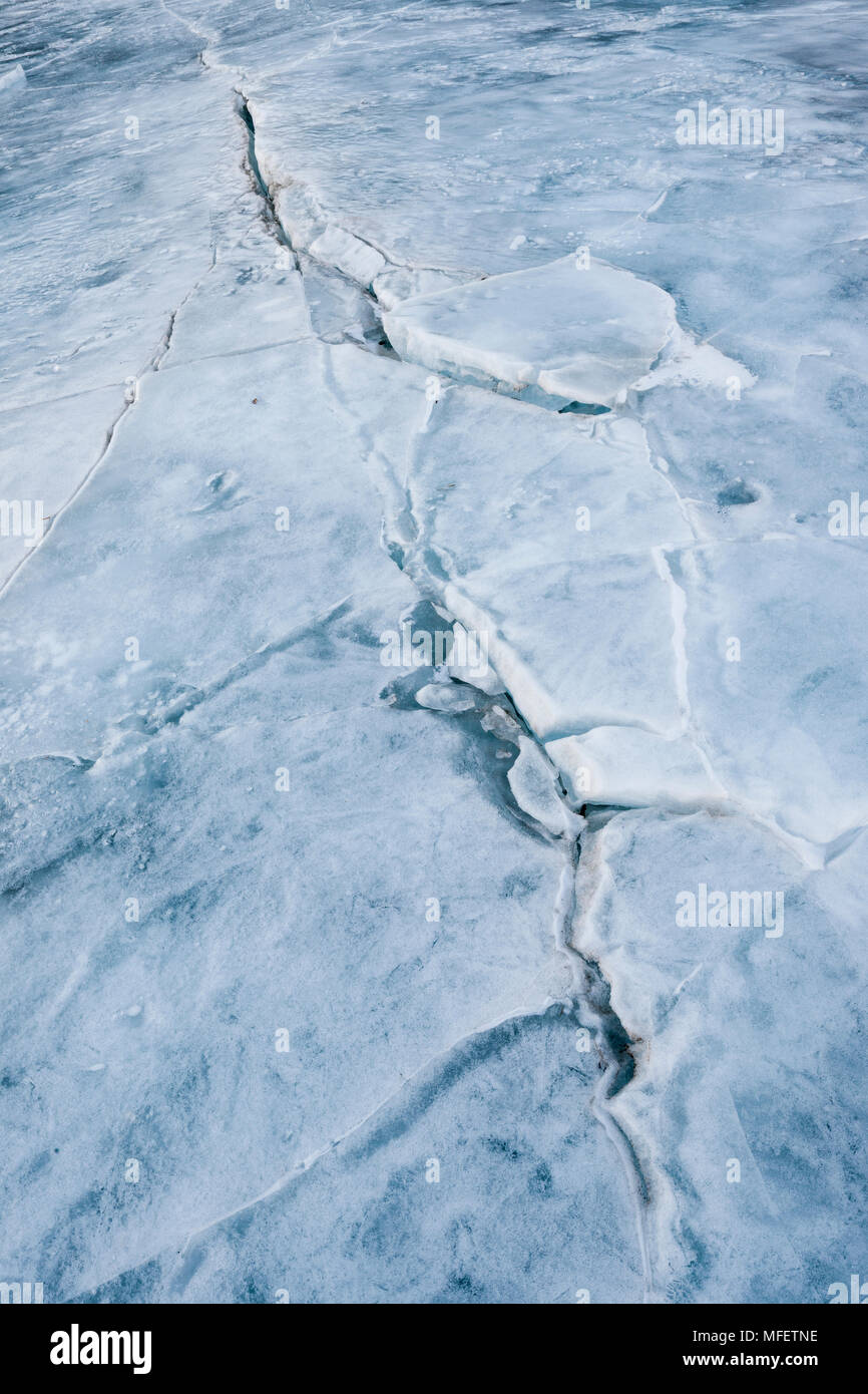 Cracks in ice on frozen lake; Alberta, Canada Stock Photo - Alamy
