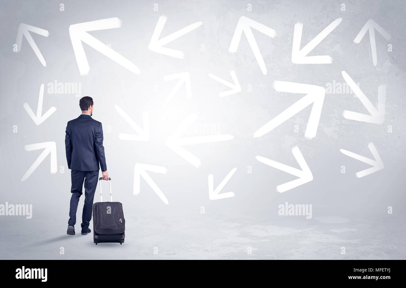 Businessman with back walking away with higgledy-piggledy arrows around ...