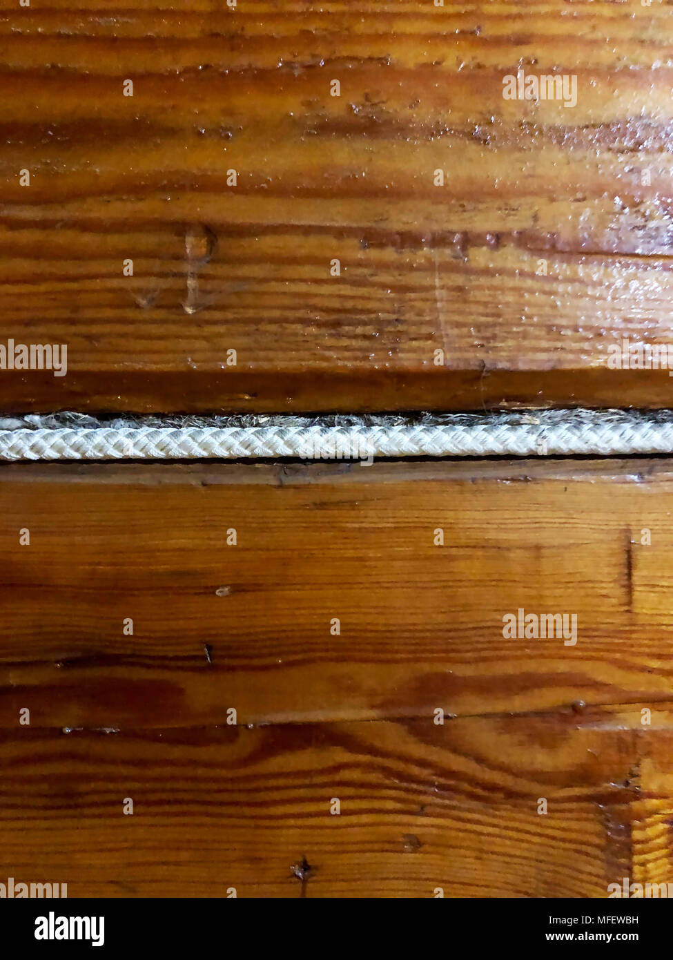Wooden background of boards with a rope in the seam Stock Photo - Alamy