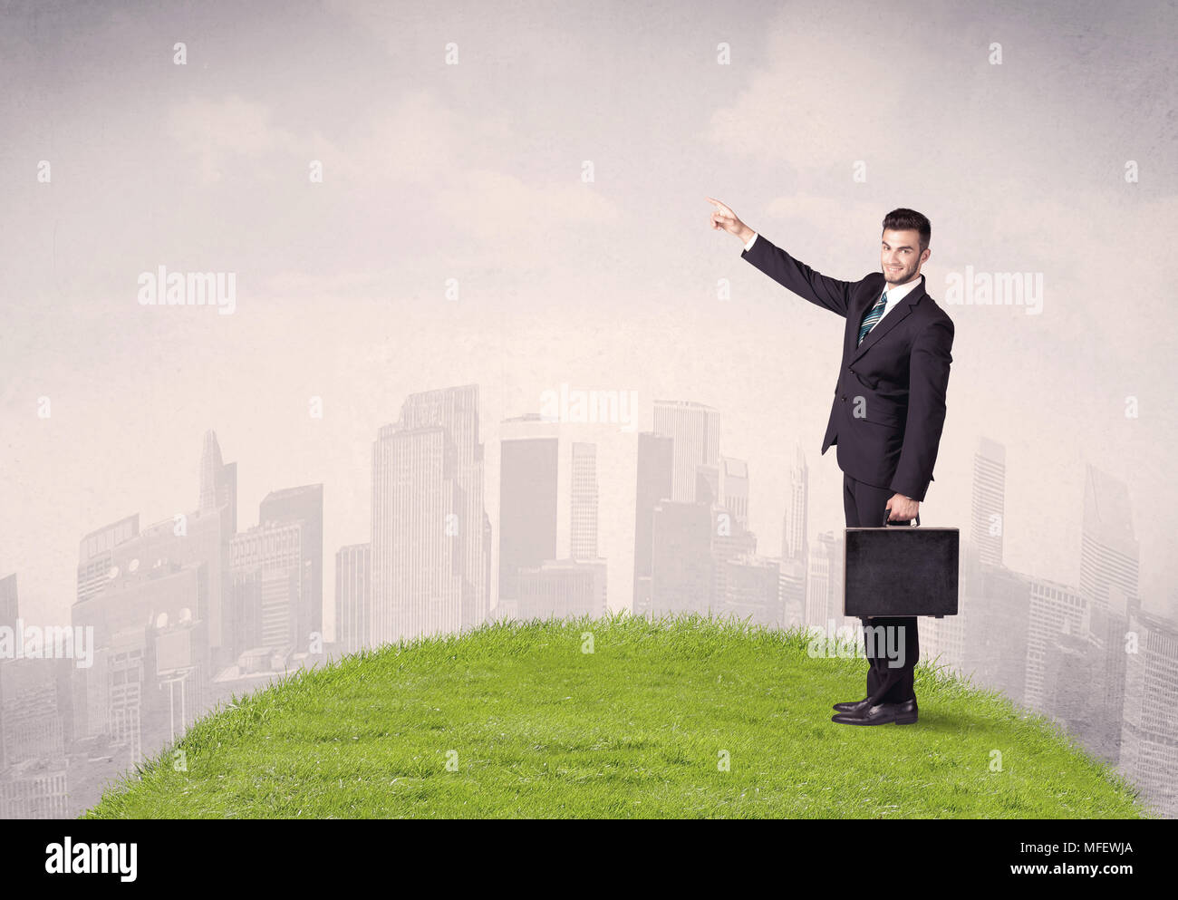 A confident male well looking office manager standing in small green ...