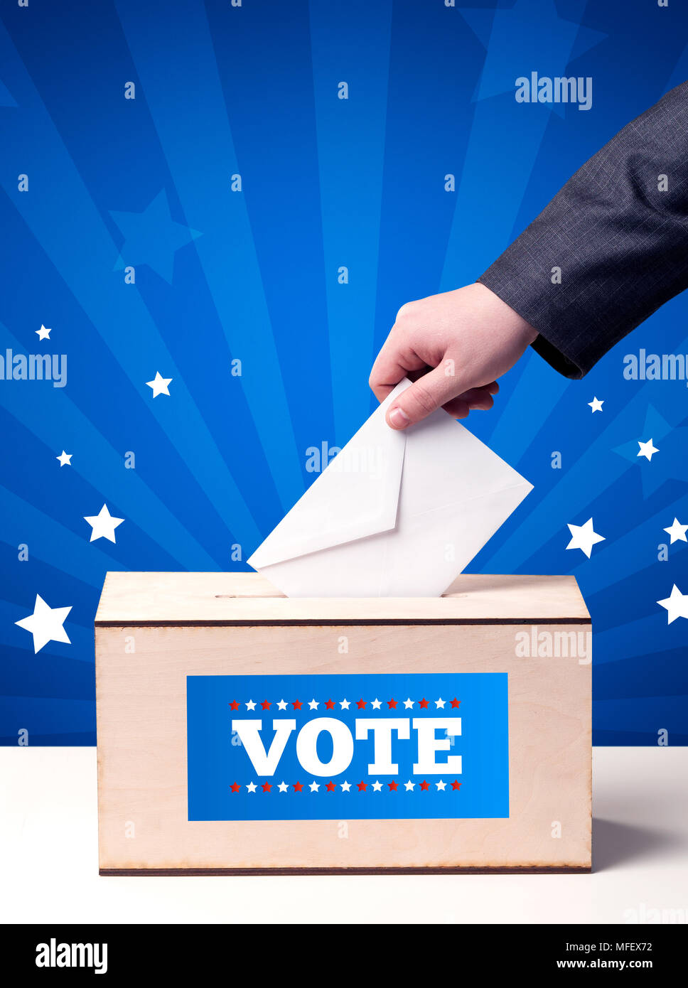 Voting hand with ballot and wooden box Stock Photo - Alamy