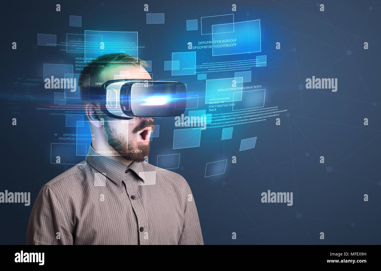 Amazed businessman with virtual reality data and blue squares in front ...