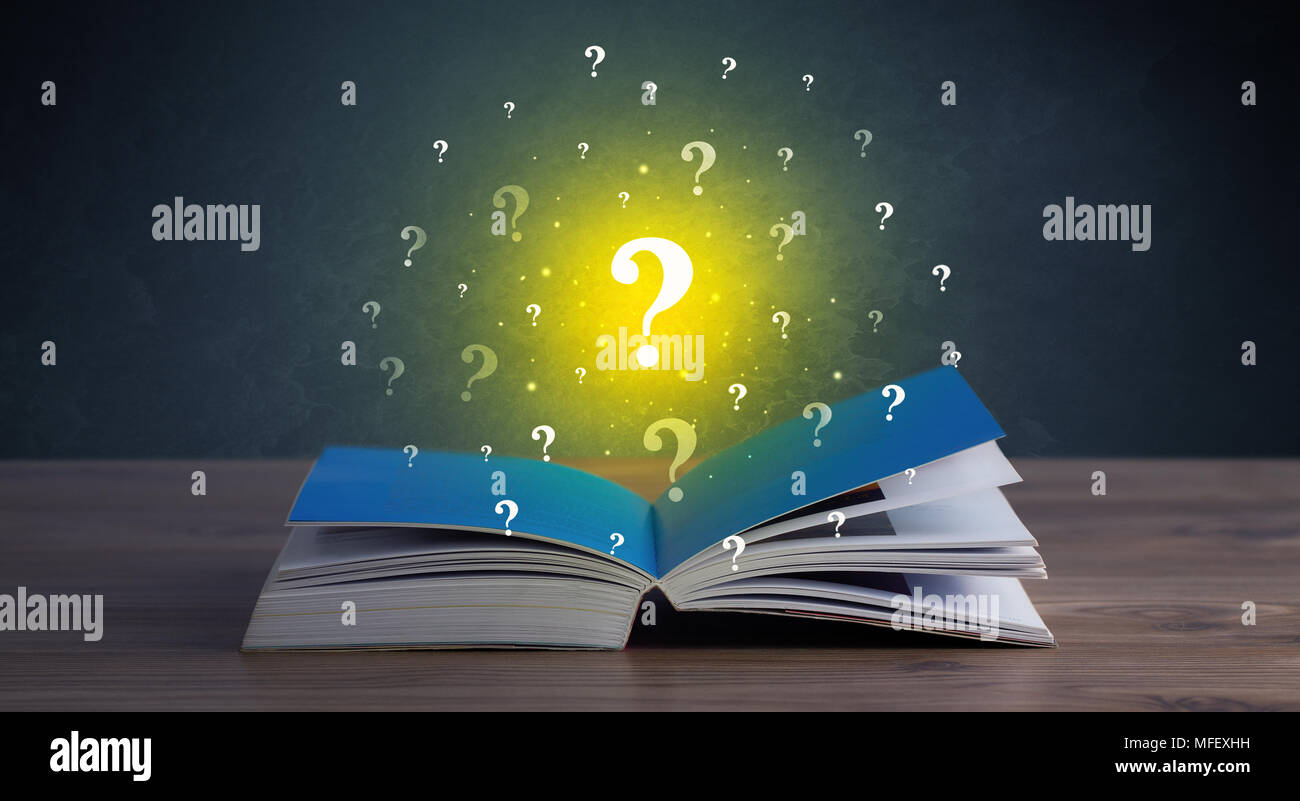 Yellow question marks hovering over open book Stock Photo - Alamy
