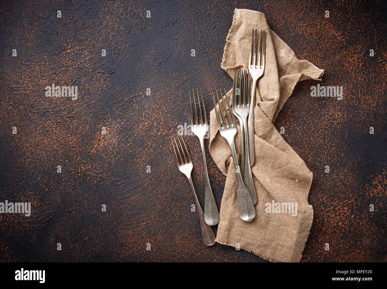 Vintage forks on rusty background Stock Photo - Alamy
