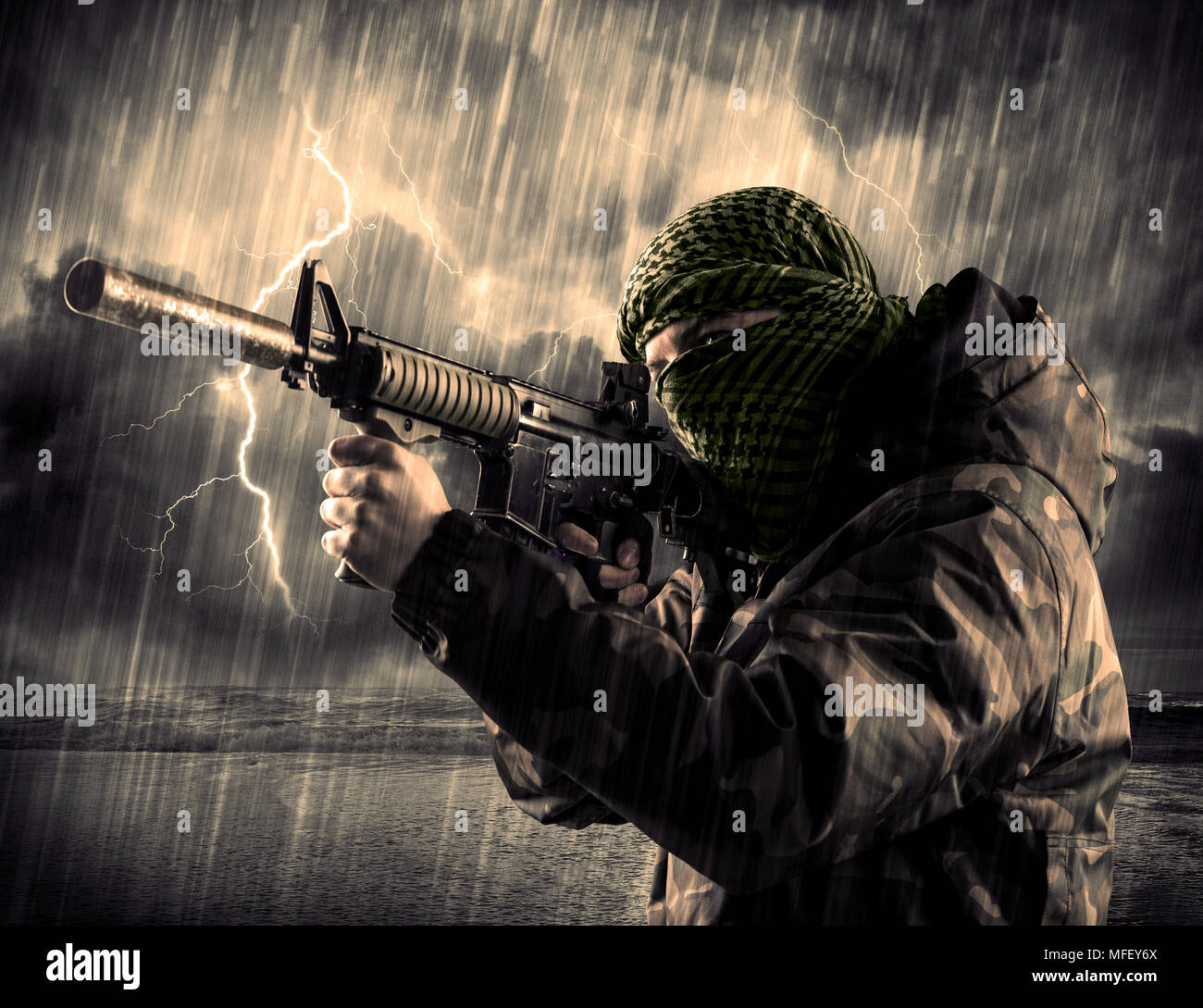 Portrait of a dangerous armed terrorist with mask and gun in a ...