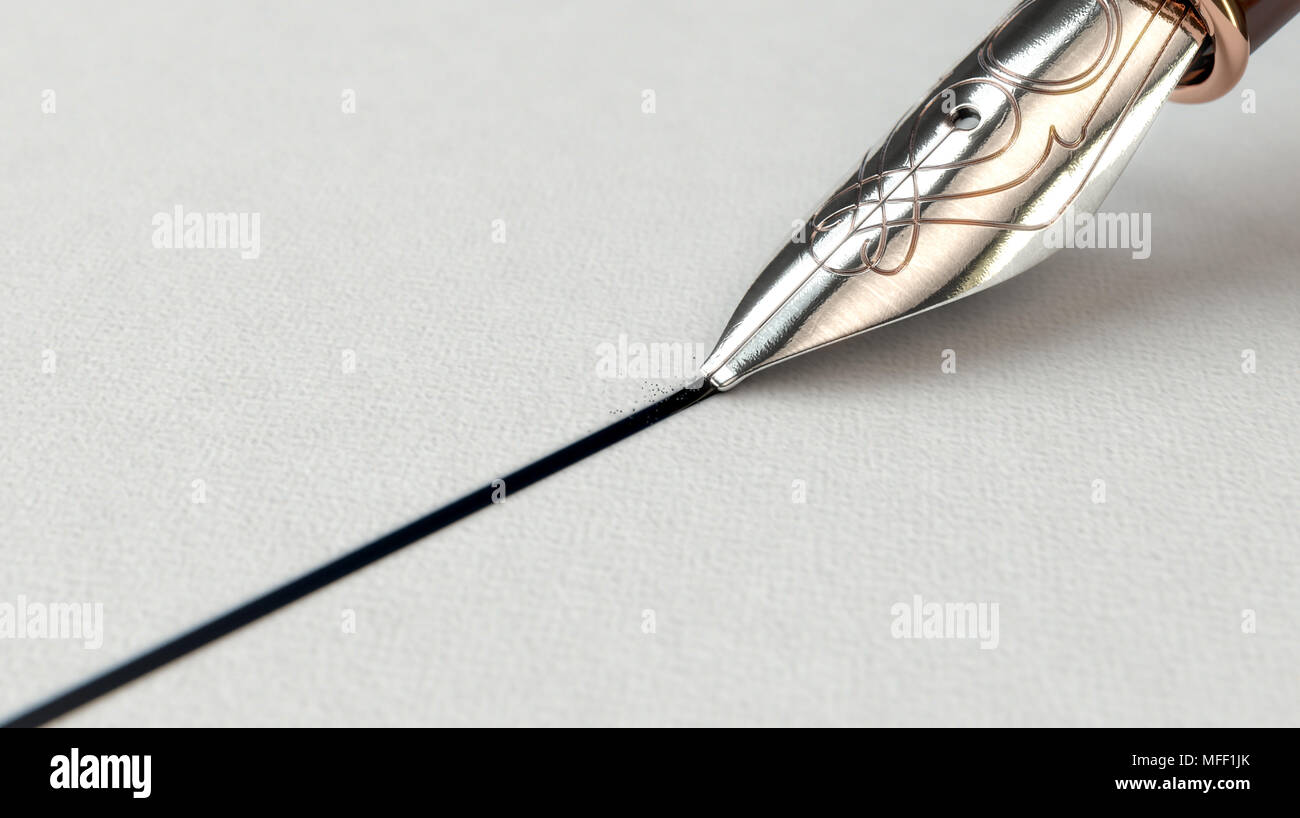 A closeup view of an ornate metal nib of an old fountain pen drawing a ...