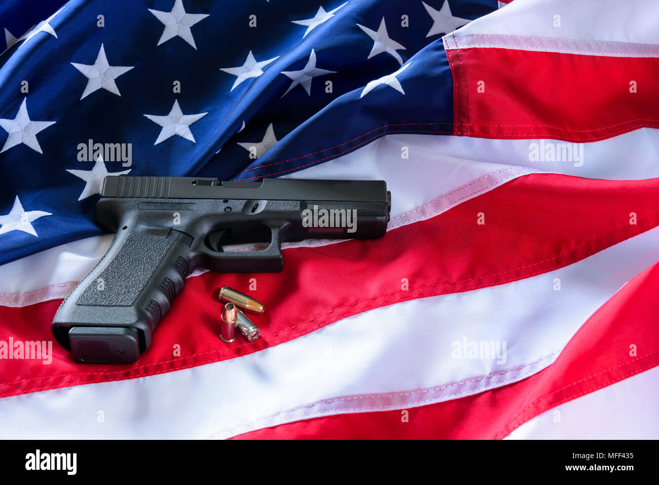 A handgun and bullets on American flag background Stock Photo - Alamy