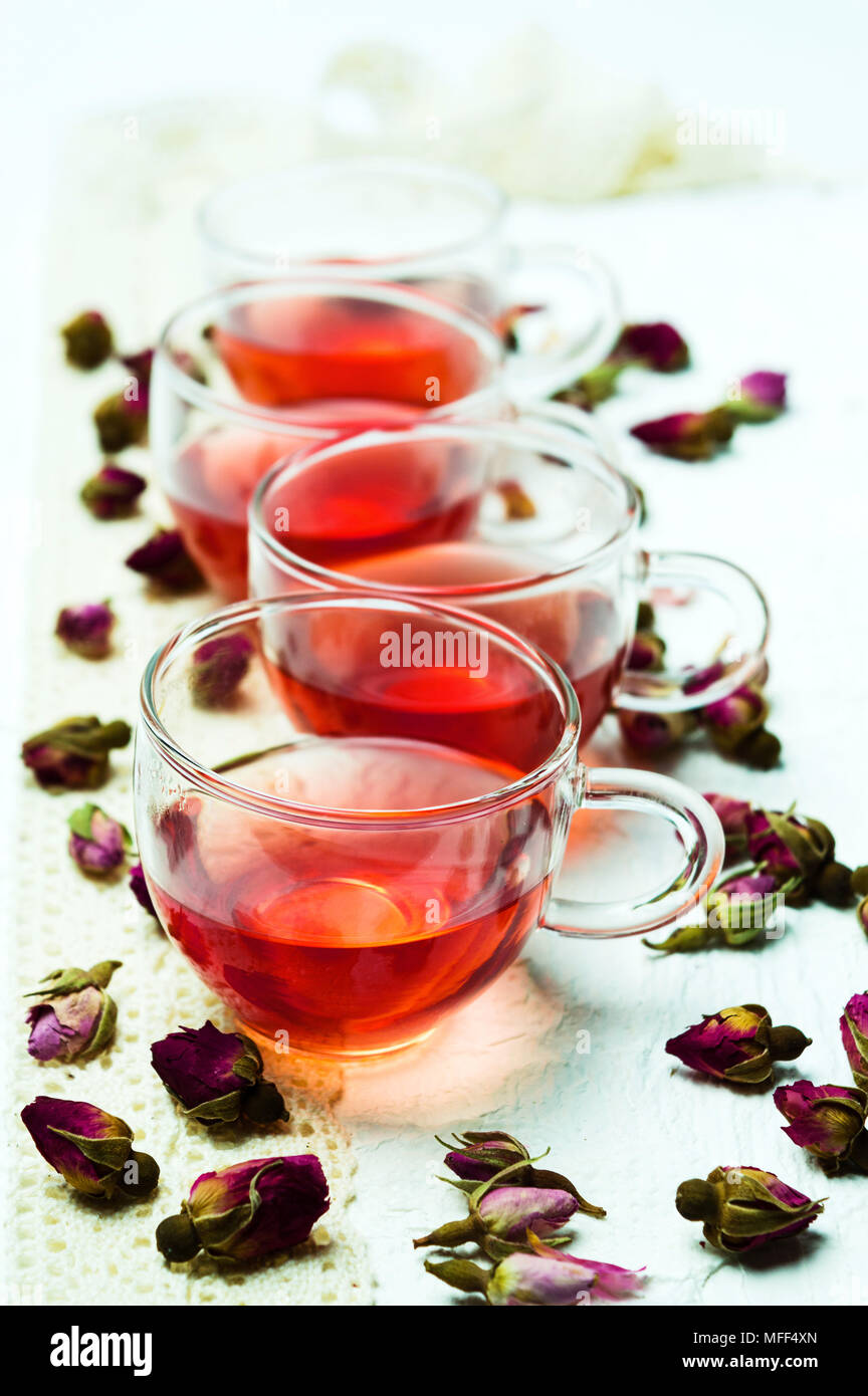 Rose tea and flower petals on white background isolated Stock Photo - Alamy