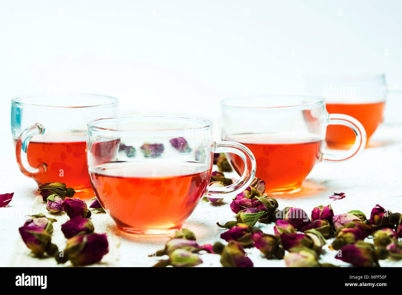 Rose tea and flower petals on white background isolated Stock Photo - Alamy