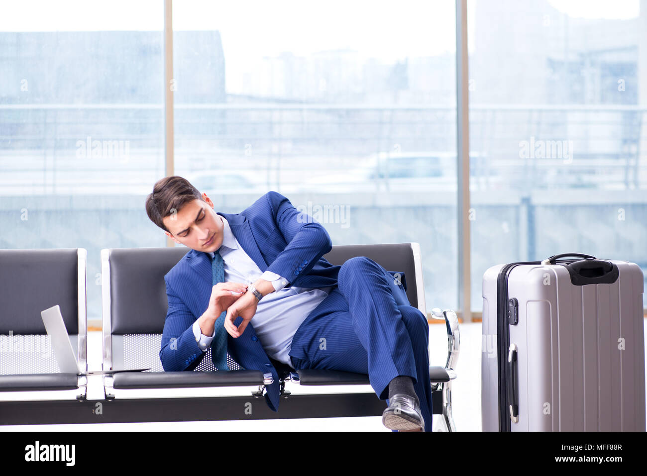 Businessman waiting at the airport for his plane in business class Stock Photo - Alamy
