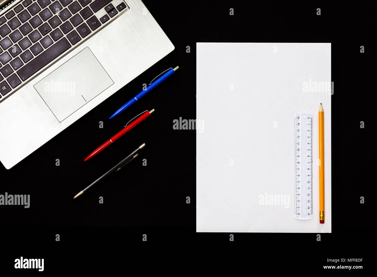 top view of office desk with blank notebook paper pen rope carabiner ...