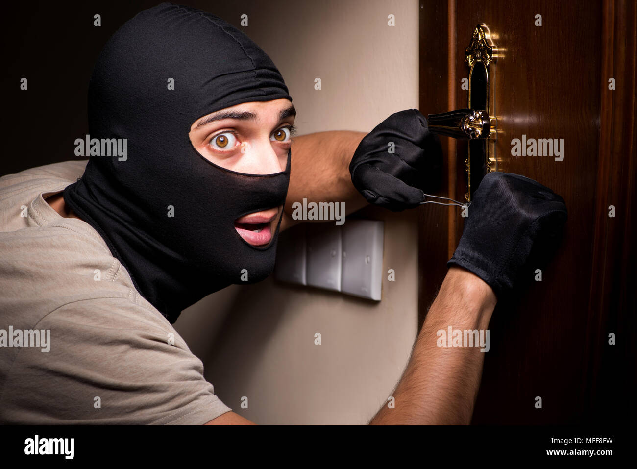 Burglar wearing balaclava mask at crime scene Stock Photo - Alamy
