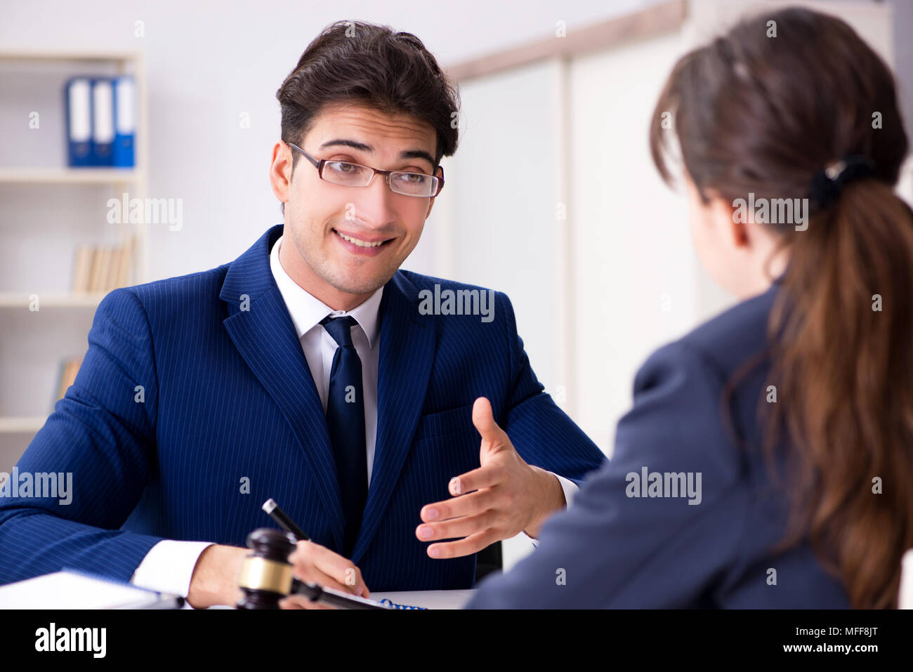 Lawyer talking to his client in office Stock Photo - Alamy