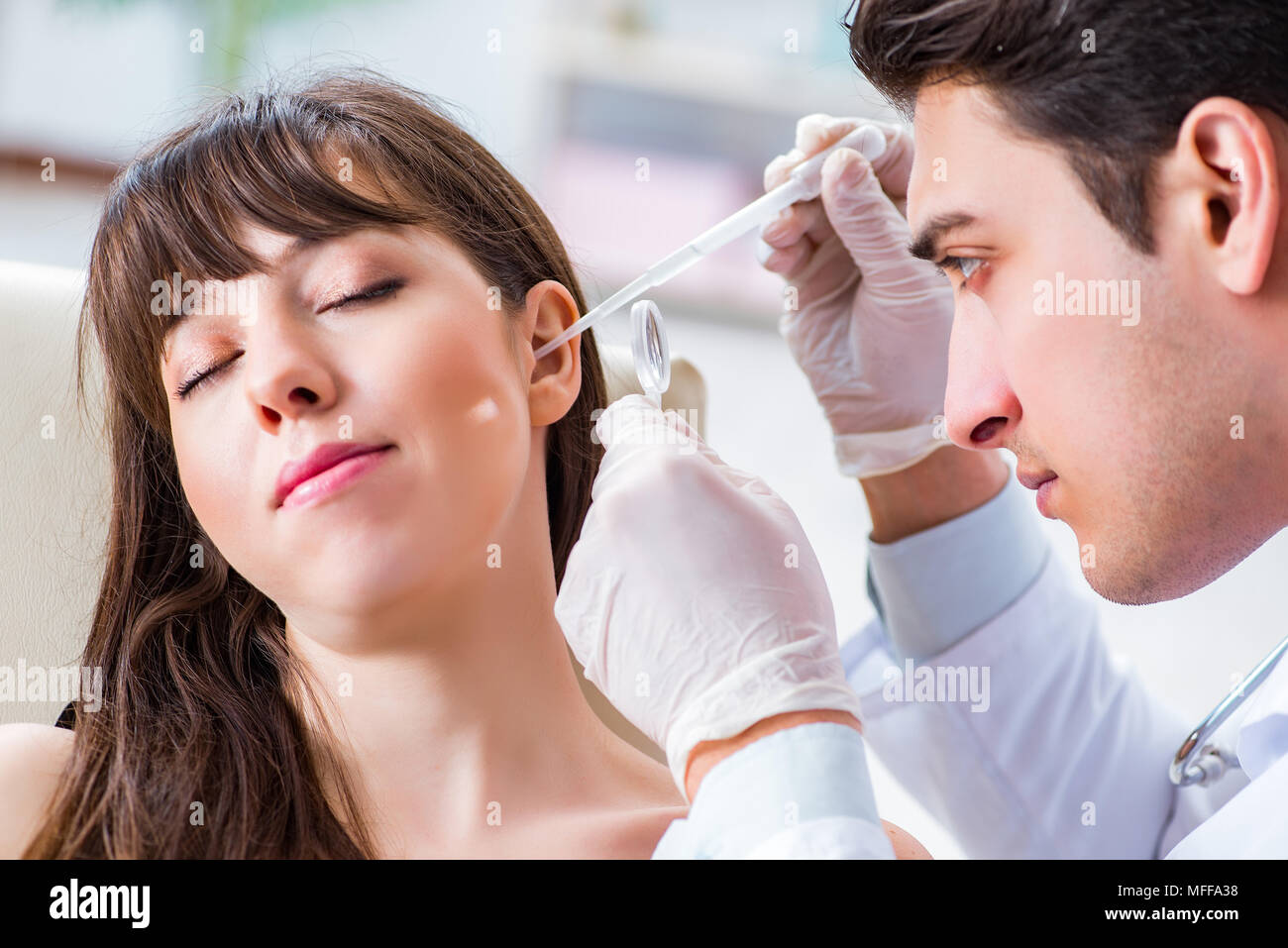Doctor checking patients ear during medical examination Stock Photo - Alamy