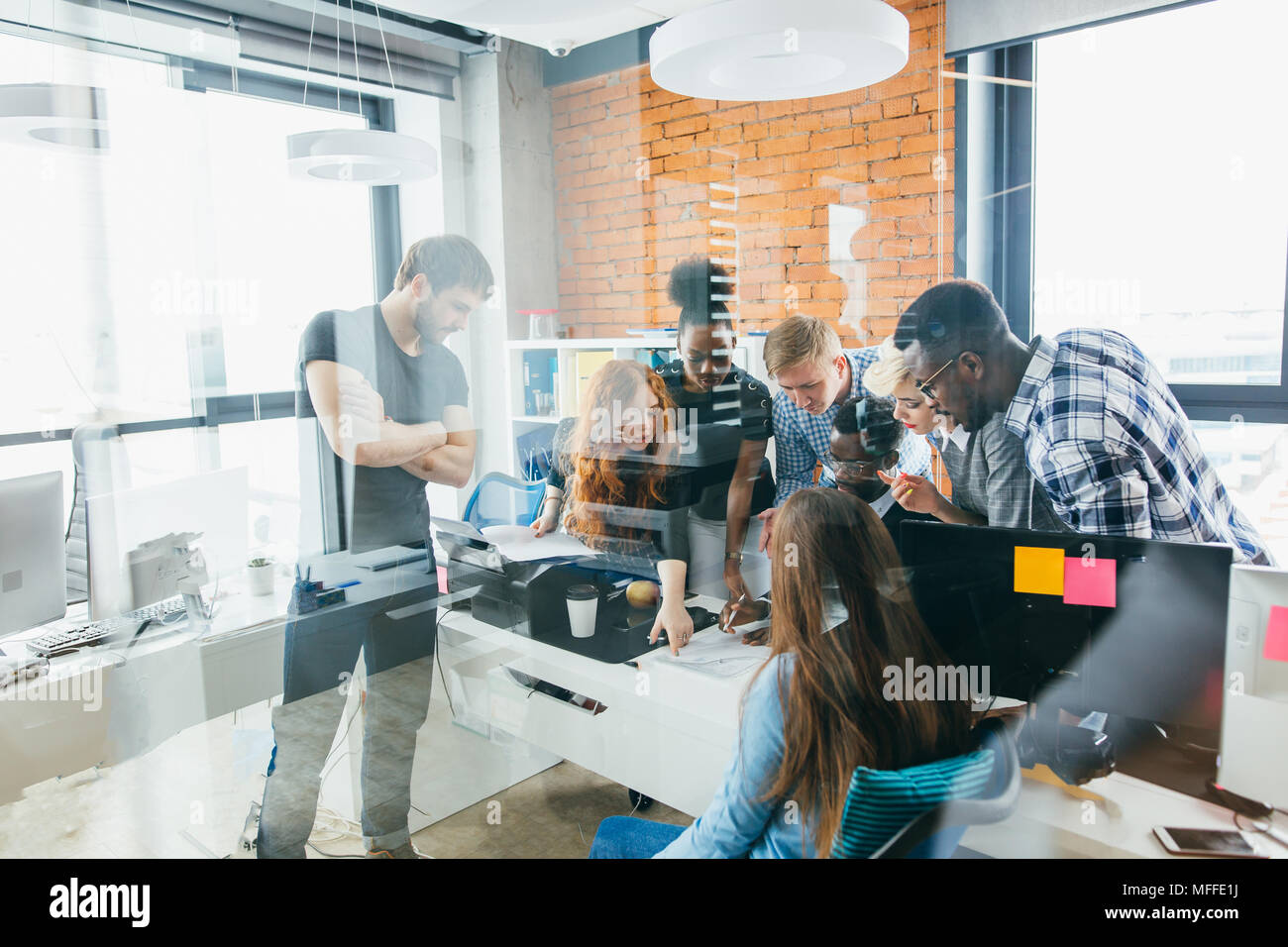 young people are helping their colleague to sign documents. write a ...