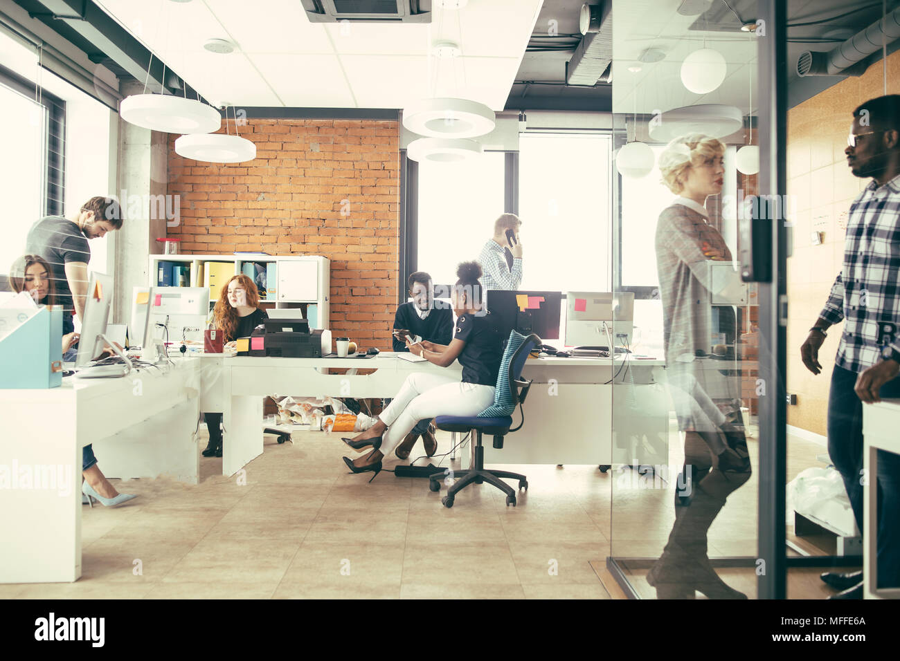 young multy ethnic people working in different ways in the light office ...