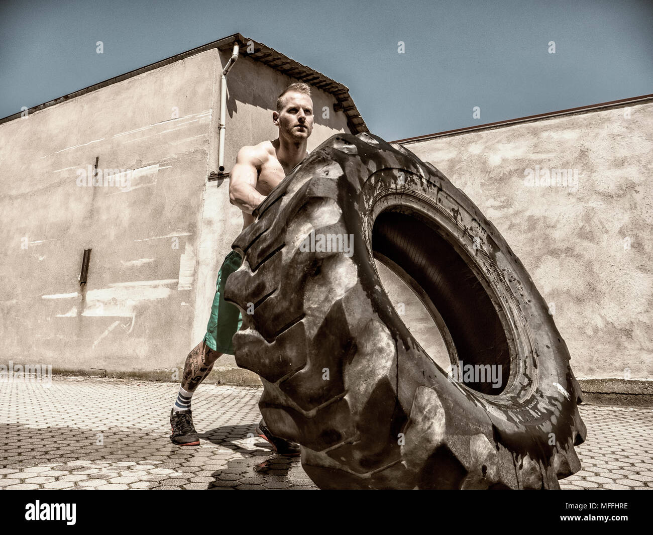 Man flipping tire hi-res stock photography and images - Alamy