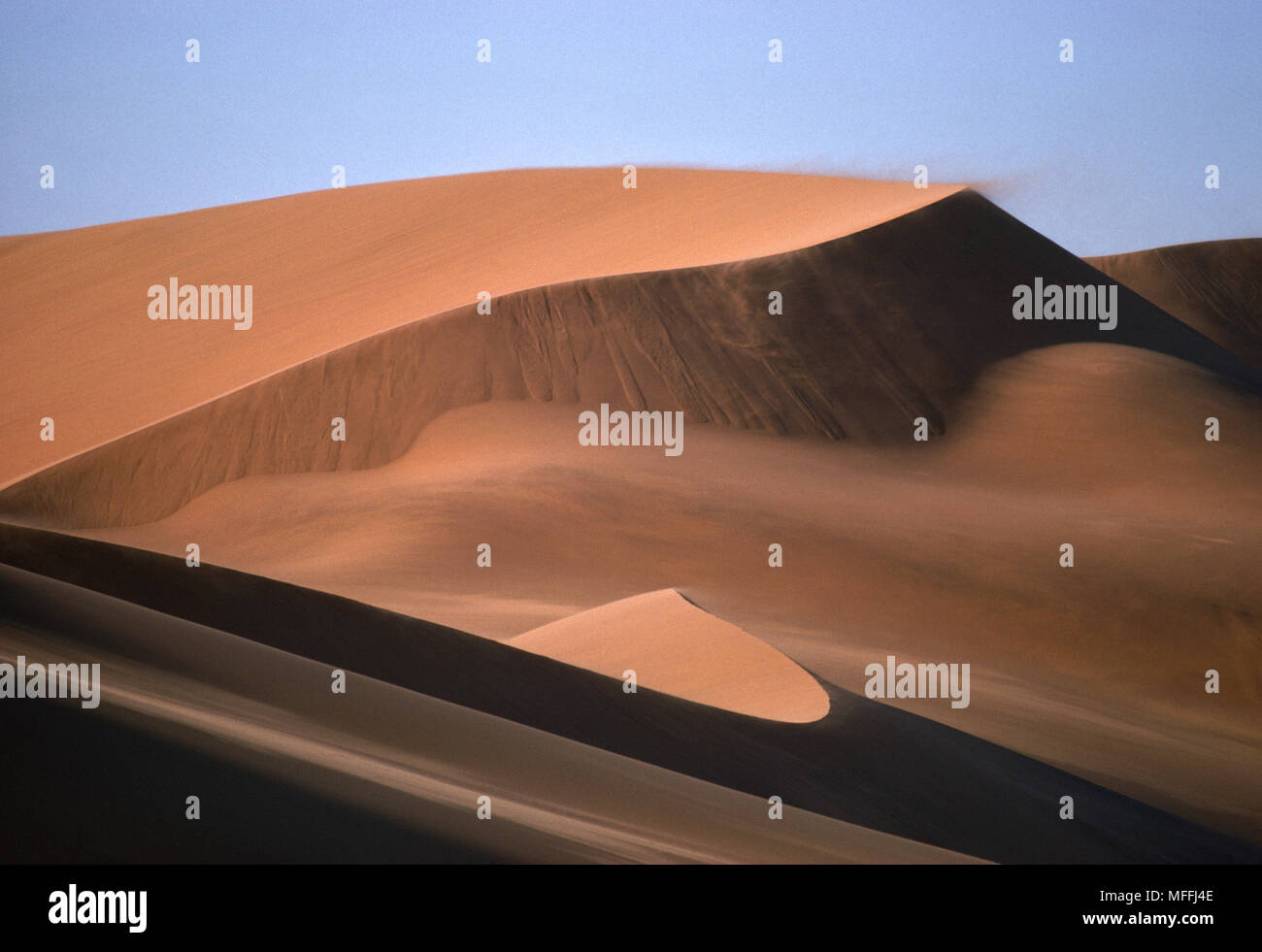 SAND DUNE FORMATION Re-forming of dune crests by east wind Namib Desert ...