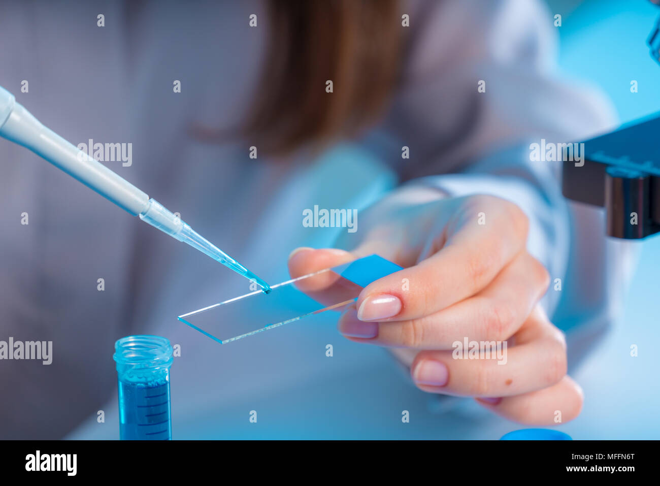 female technician take sample on microscope slide Stock Photo - Alamy