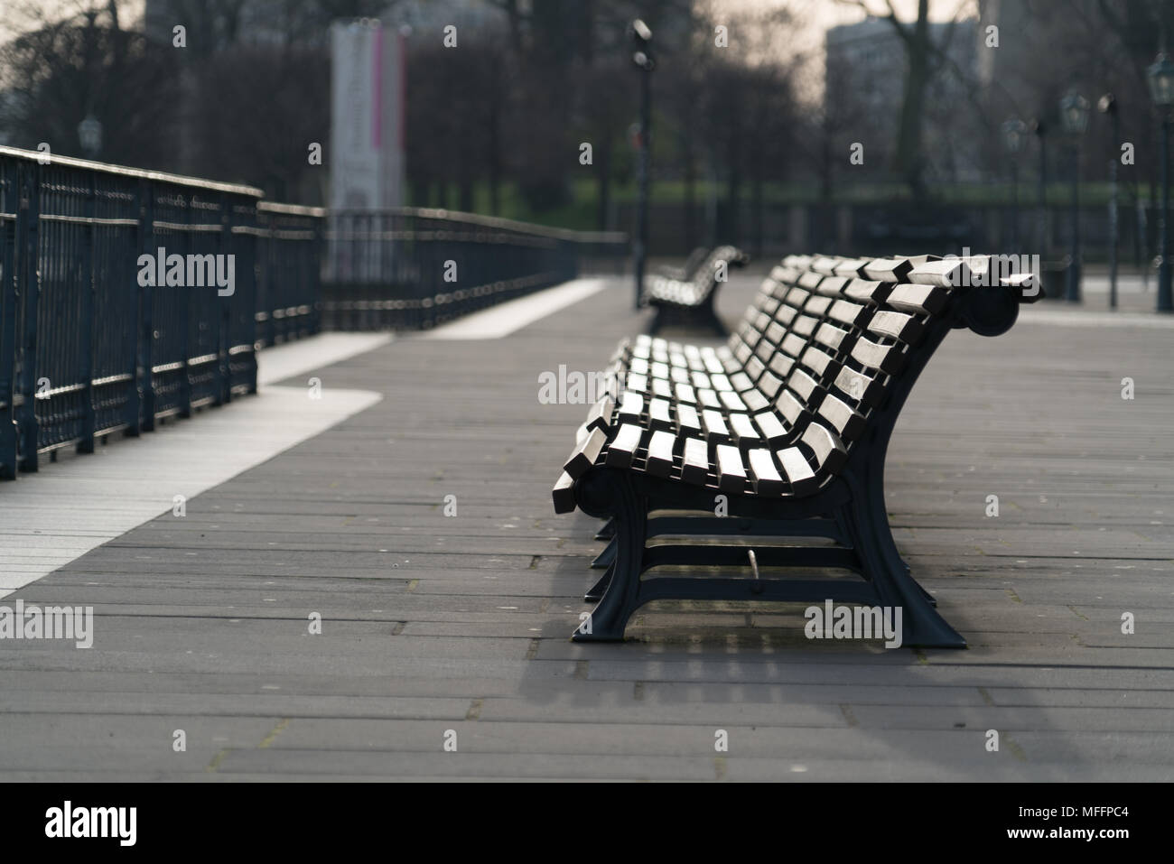 Wooden bench in the city Stock Photo - Alamy