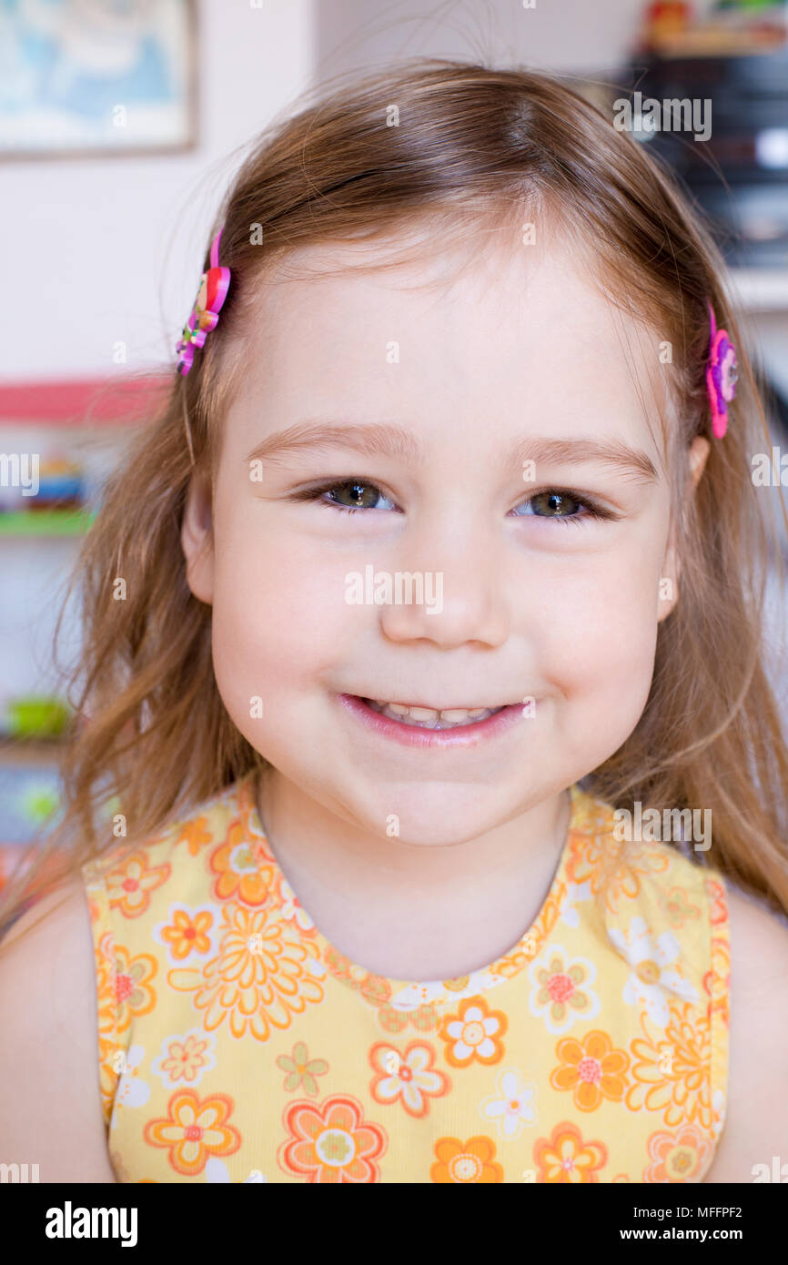 portrait of three years old blonde pretty girl face, with yellow dress ...