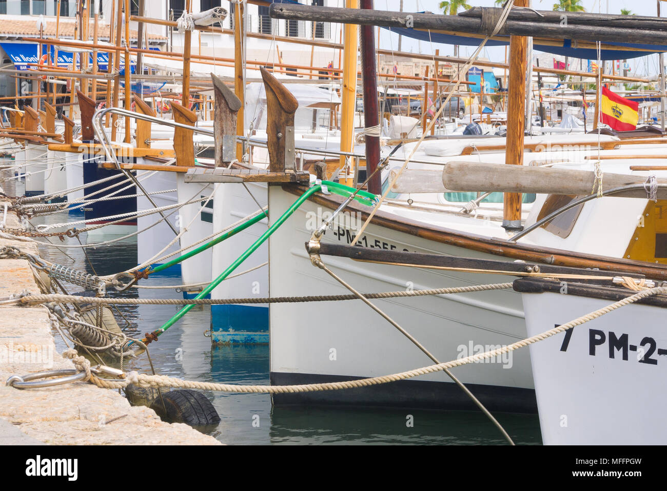 A row of yachts are secured to a mooring with ropes in a marina in Port ...