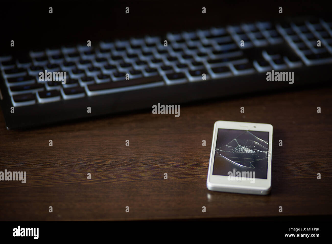 smartphone with broken screen on the background of the old backlit ...