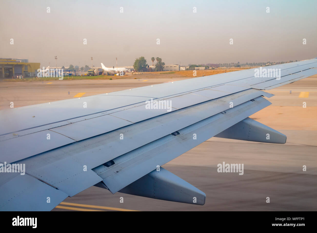 Airplane wing on the runway at ben gurion airport on sunrise Stock ...