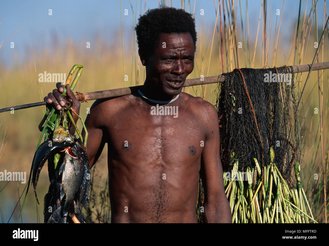BAYEI FISHERMAN with his net & catch (subsistance fishing) Okavango ...