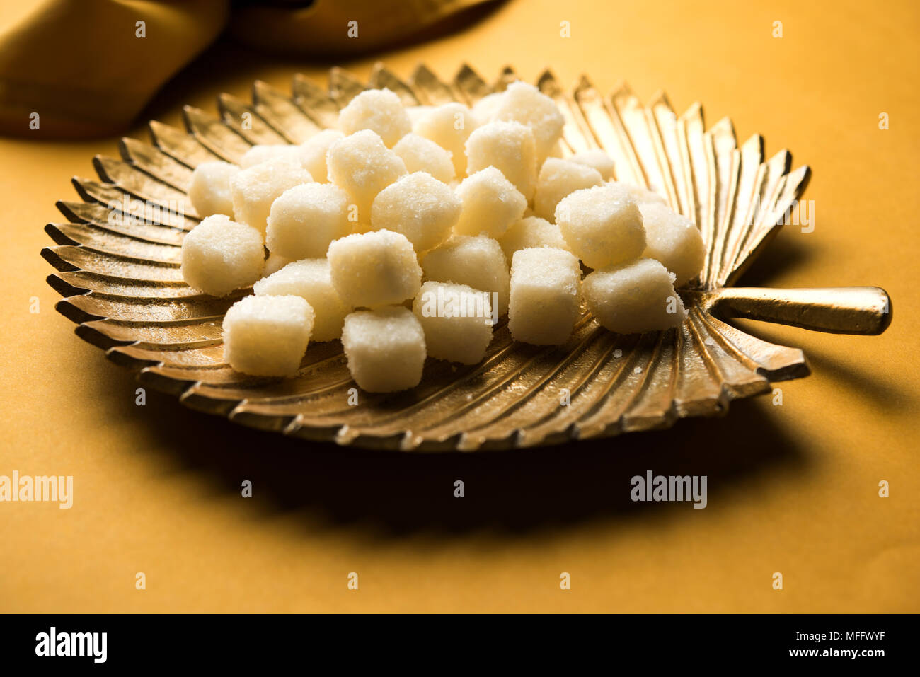 Bengali Sweet Chena Murki served in a golden plate, selective focus ...